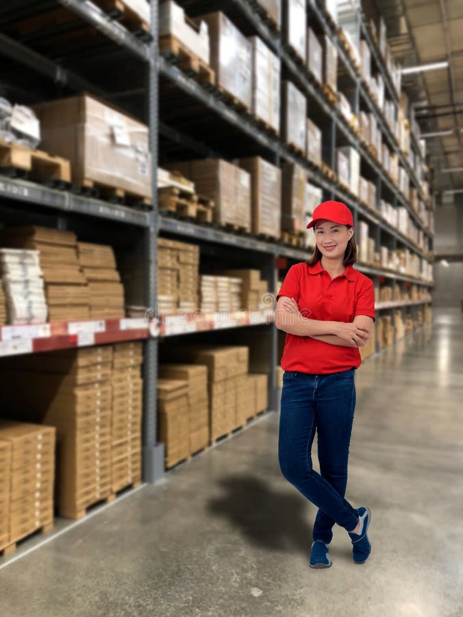 Woman Operator in Uniform with Blurred the Background of the Warehouse ...