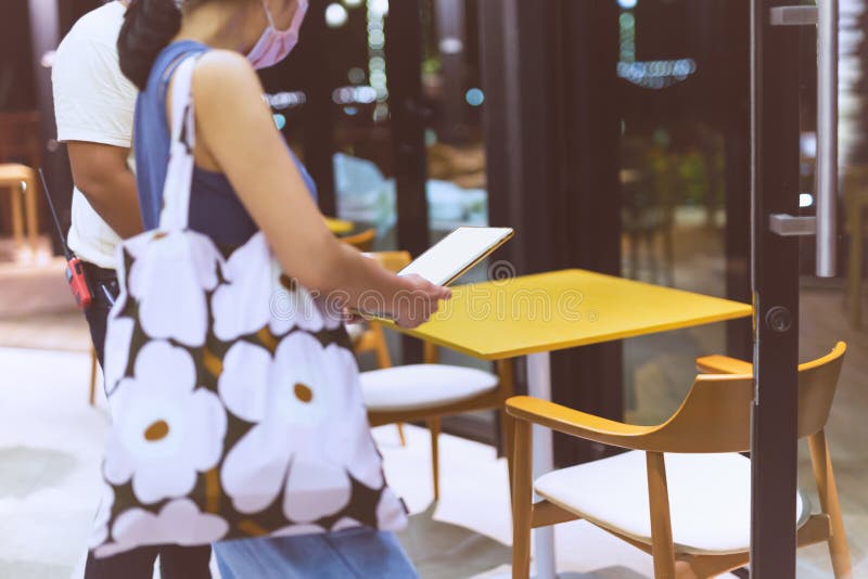 Woman Ordering Meal Using Tablet Computer in Restaurant. Stock Photo ...