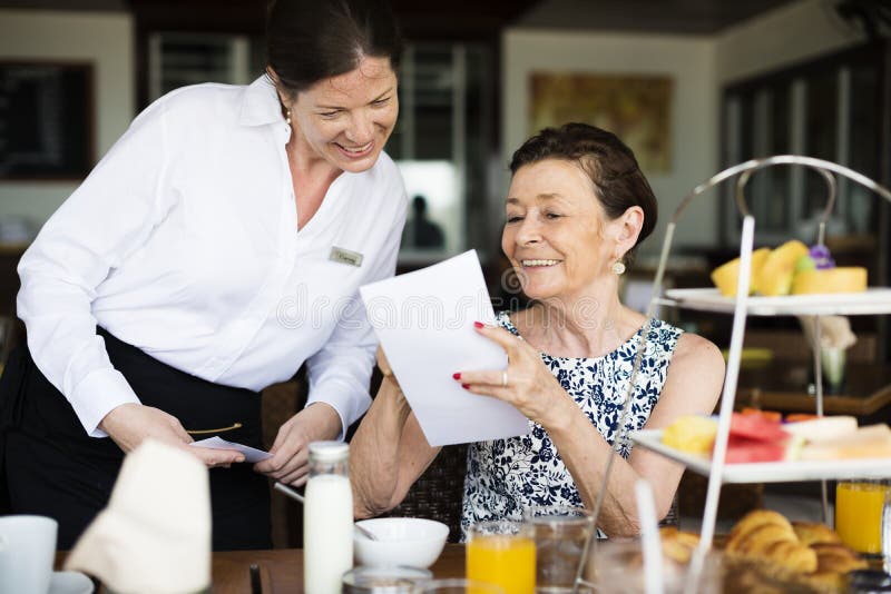 Woman Ordering from a Menu at Restaurant Stock Image - Image of ...