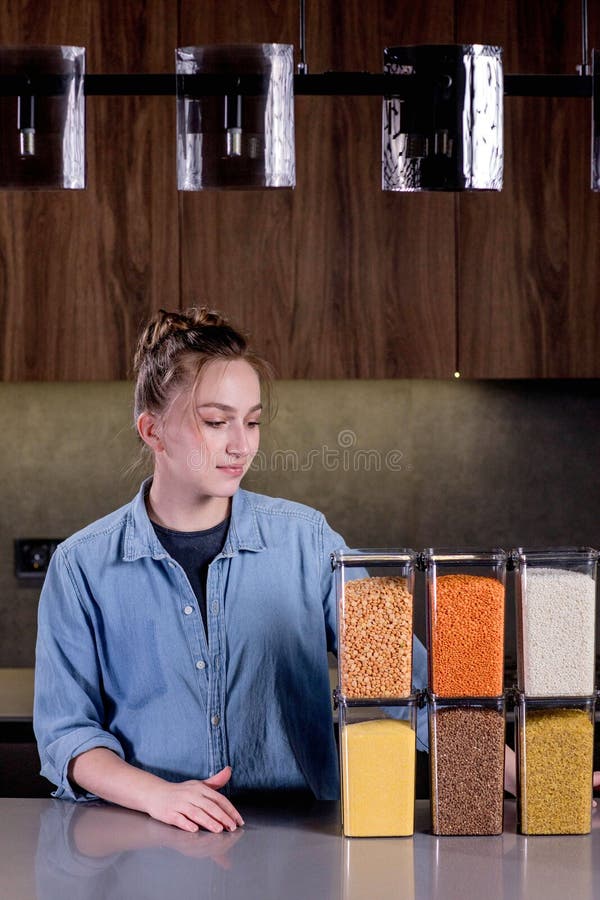 Woman Organizing Food in the Kitchen with Containers Stock Photo ...