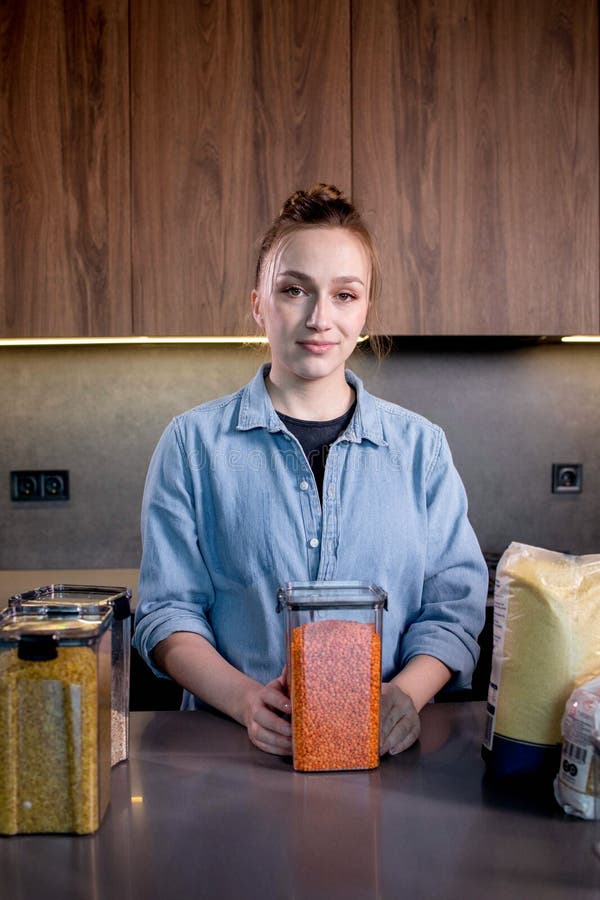 Woman Organizing Food in the Kitchen with Containers Stock Photo ...