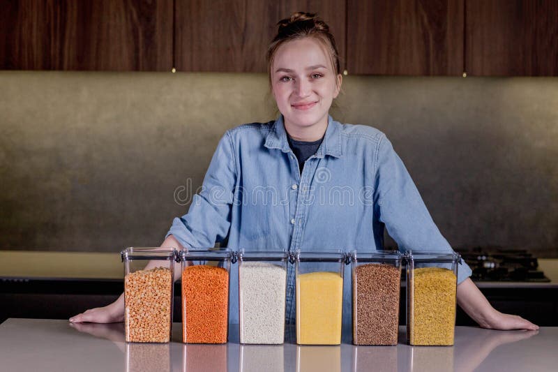 Woman Organizing Food in the Kitchen with Containers Stock Photo ...