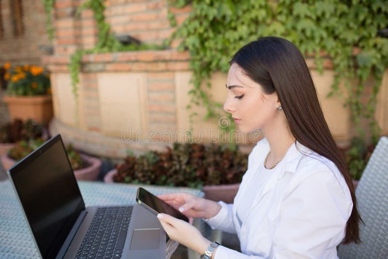 Woman Outdoors with Laptop Working in Outdoor Cafe Stock Image - Image ...