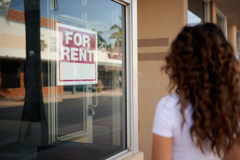 Woman outside empty store stock photo. Image of back - 180398480