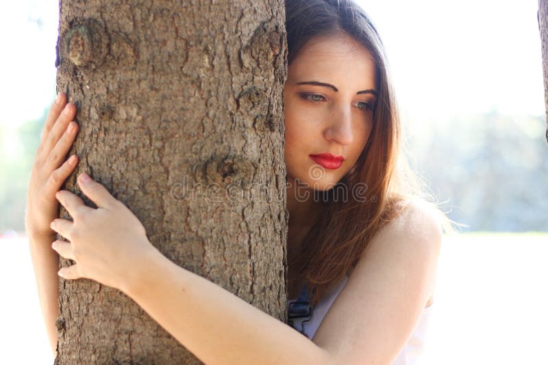 Woman in Overalls Stands between Tree Trunks Stock Photo - Image of ...