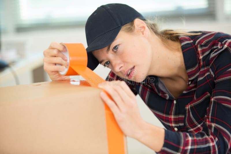 Woman packaging taping box stock photo. Image of product - 164156366