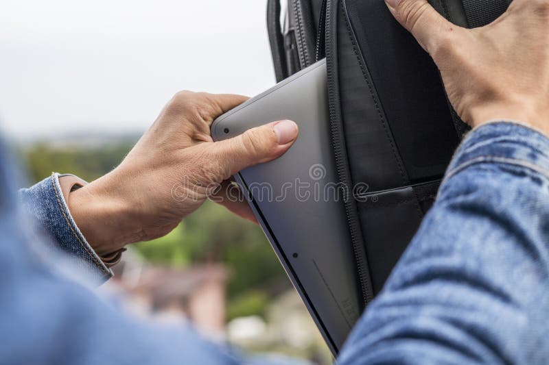 Woman Packing a Laptop in Backpack Stock Photo - Image of jacket ...