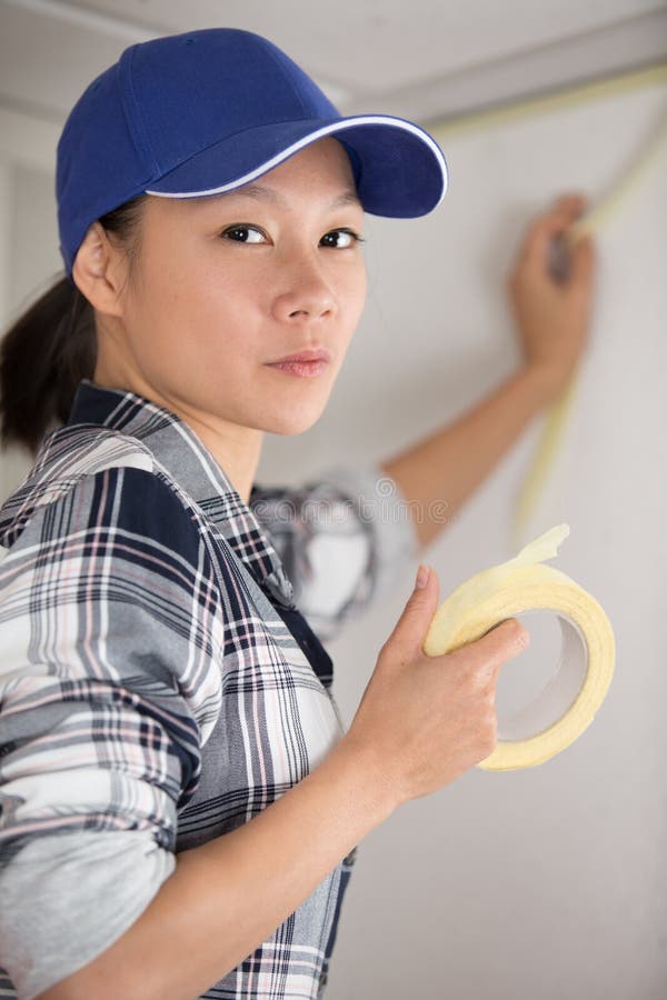 Woman Painter with Masking Tape before Painting Stock Image - Image of ...