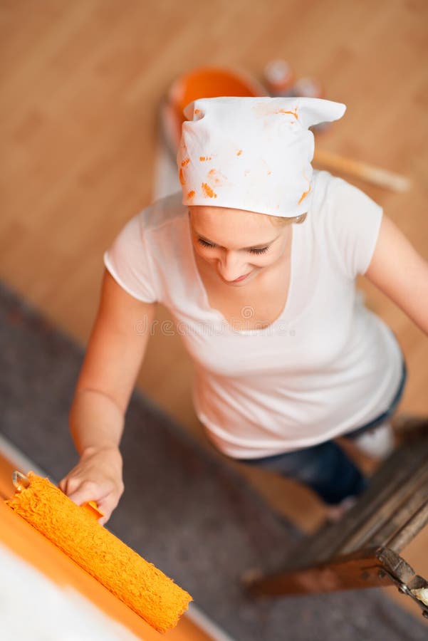 Woman Painting a Wall with Paint Roll Stock Image - Image of incomplete ...