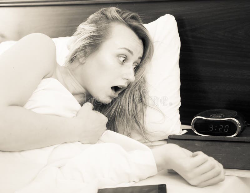 Woman in Panic Looks at Clock Stock Photo - Image of pillow, attractive ...