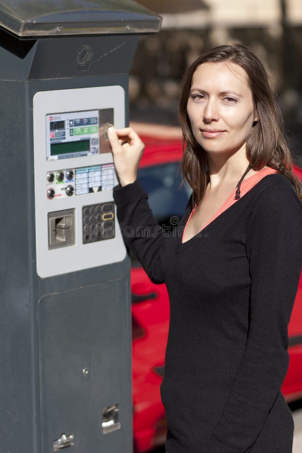 Woman on parking meter stock photo. Image of token, city - 31401250
