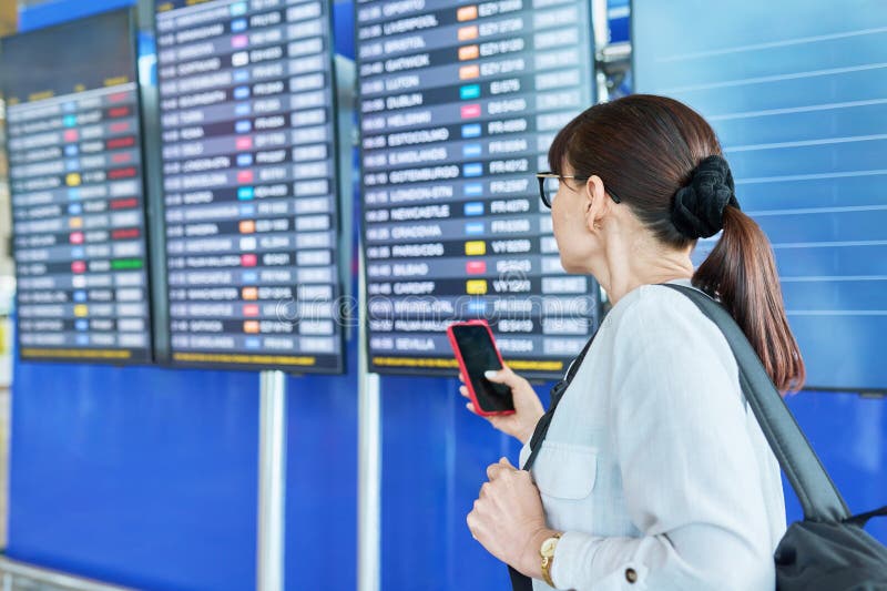 Woman Passenger Looking at Flight Schedule Board at Airport Stock Image ...