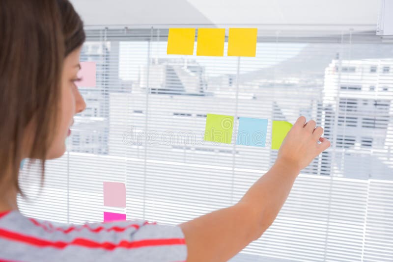 Woman pasting sticky note stock image. Image of colourful - 31010051