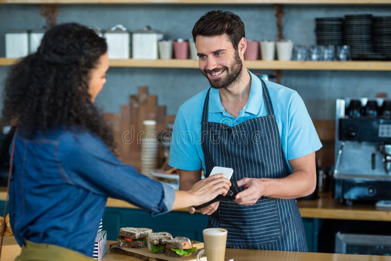 Woman Paying Bill through Smartphone Using NFC Technology Stock Photo ...