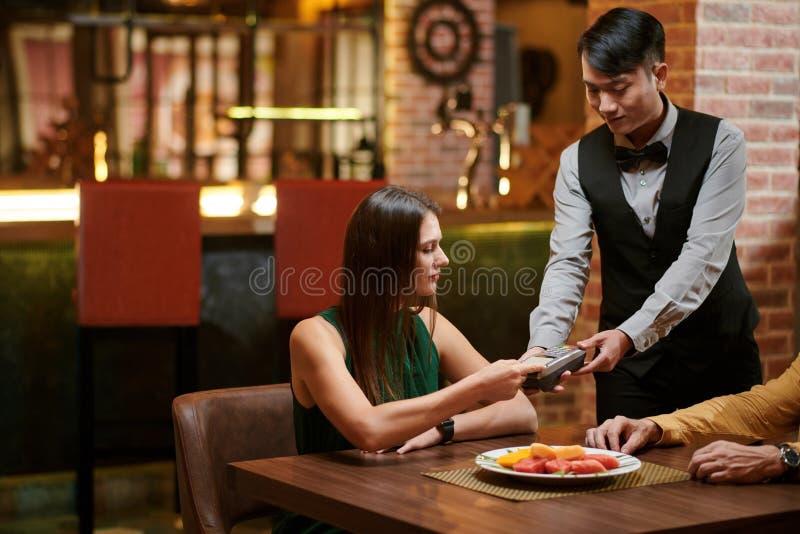 Woman Paying for Dinner stock photo. Image of birthday - 260934588