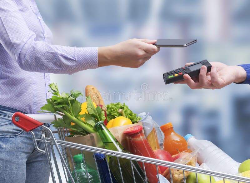 Woman Paying for Groceries Using Her Smartphone Stock Photo - Image of ...