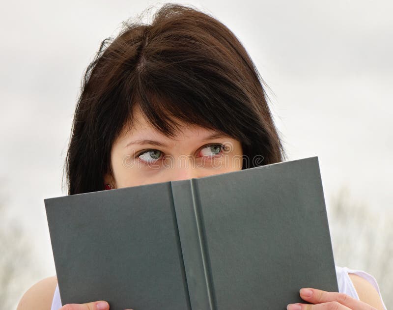 Woman Peeking Over Edge of Book Stock Photo - Image of woman, female ...