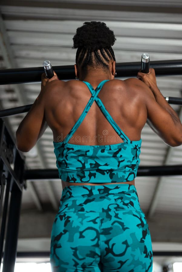 A Woman is Performing an Overhead Pull - Ups on a Parallel Bar Stock ...