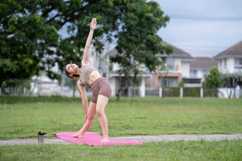 Woman in Triangle Pose during Outdoor Yoga Session Stock Photo - Image ...