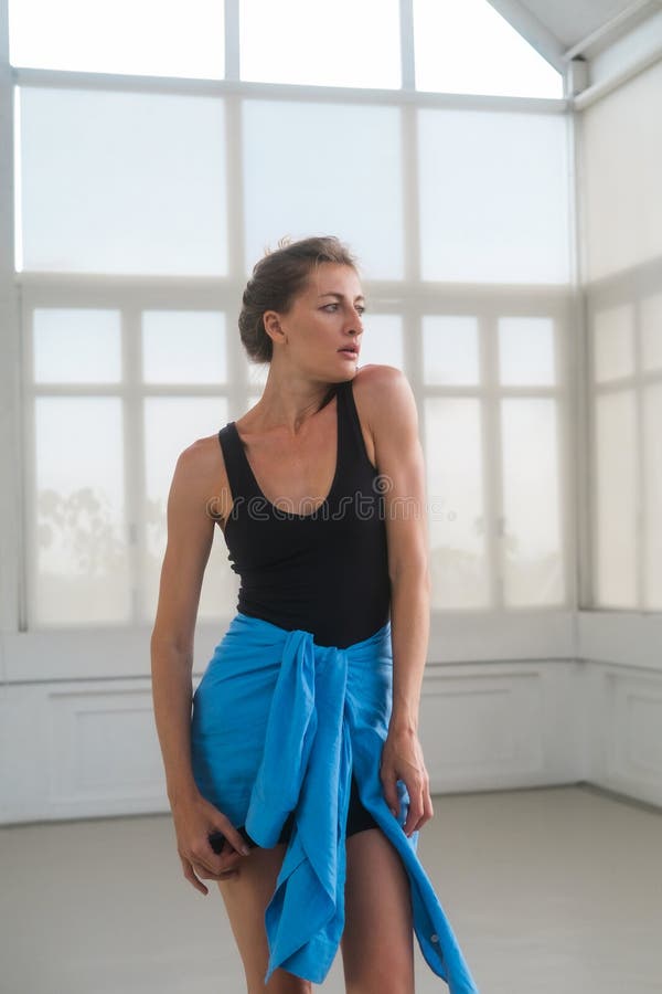 A Woman Performs a Contemporary Dance in a Bright Studio with Large ...