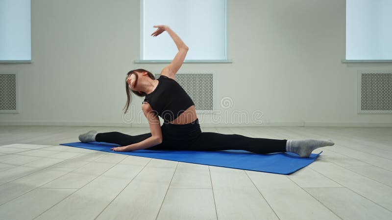 Woman Practicing Yoga Splits on Blue Mat Stock Footage - Video of body ...