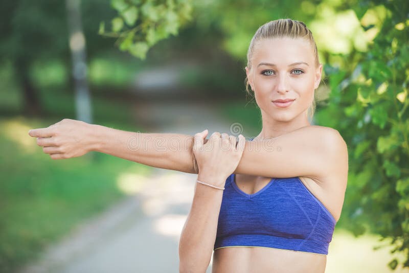 Woman Performs Stretching before Jogging Stock Image - Image of grass ...