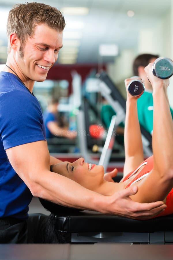 Woman and Personal Trainer in Gym, with Dumbbells Stock Photo - Image ...