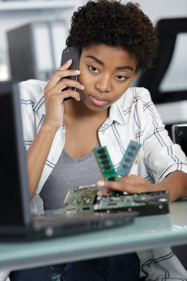 Woman on phone fixing pc stock photo. Image of internet - 186134286