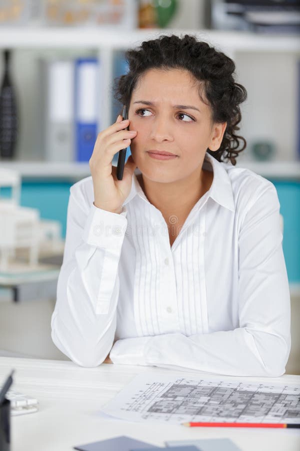 Woman on Phone in Modern Office Sitting on Desk Stock Photo - Image of ...