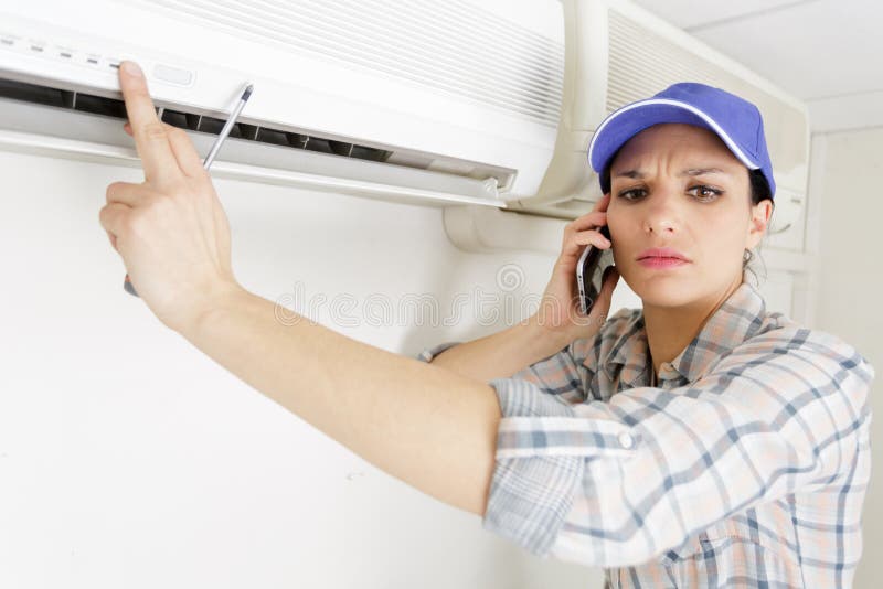 Woman on Phone Trying To Fix Cooler Stock Image - Image of handicapped ...