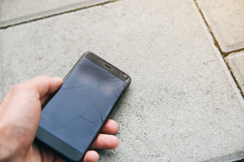Woman is Picking Up Broken Smartphone Lying on the Road Outdoors ...