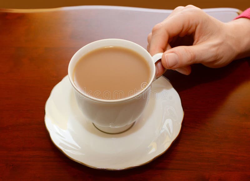 Woman Picking Up a Cup of Tea from a Table Stock Image - Image of ...