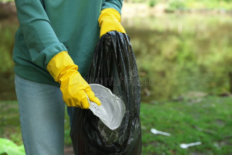 Woman with Plastic Bag Collecting Garbage in Park, Closeup. Space for ...