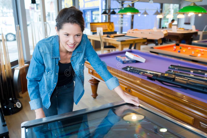 Woman Playing Pinball Machine Stock Photo - Image of establishment ...