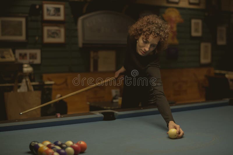Woman Playing Pool at a Bar Stock Photo - Image of dark, single: 107856122