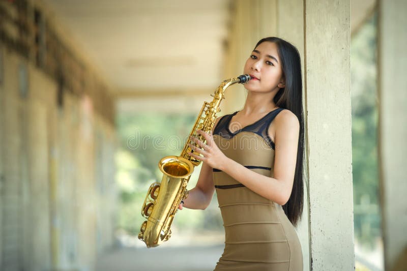 Woman playing saxophone stock photo. Image of happiness - 86638276