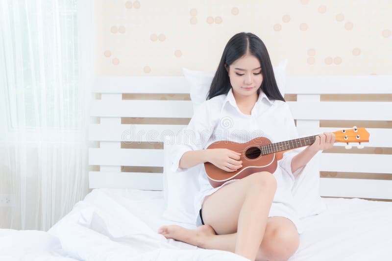 Woman playing ukulele stock image. Image of beautiful - 93591901