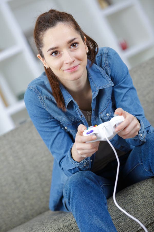 Woman playing video game stock image. Image of sofa - 296369909