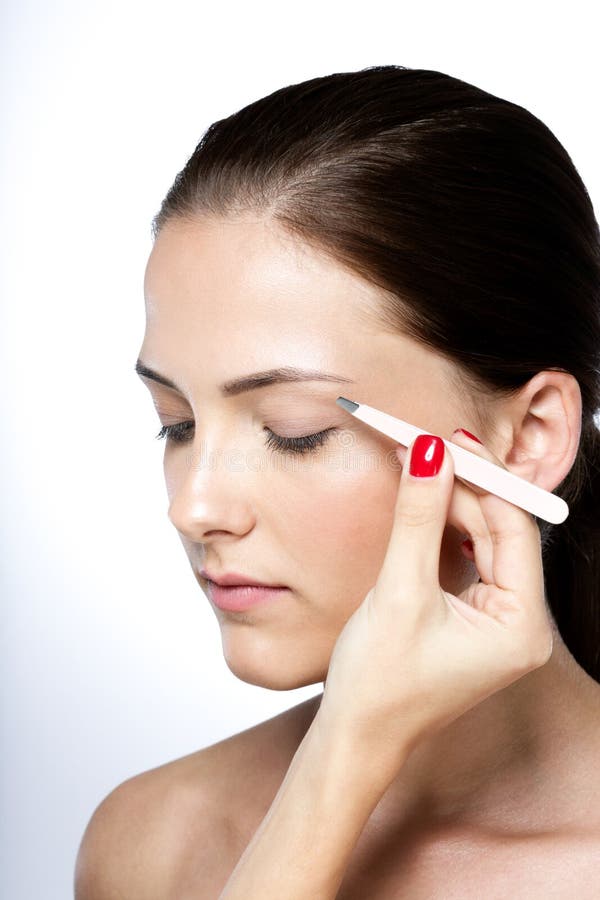 Woman plucking eyebrows stock photo. Image of mirror - 48848036