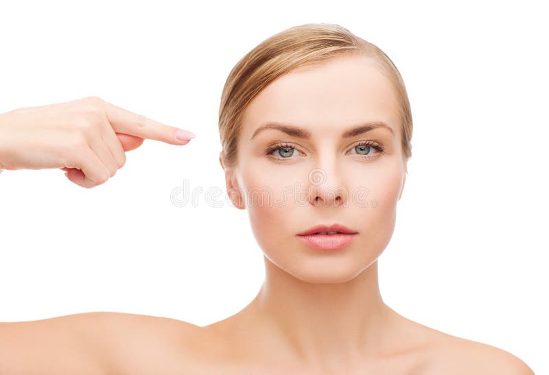 Woman pointing at her face stock photo. Image of facial - 38430498
