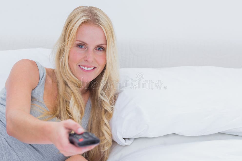Woman Pointing Remote Control at the Camera Stock Image - Image of ...