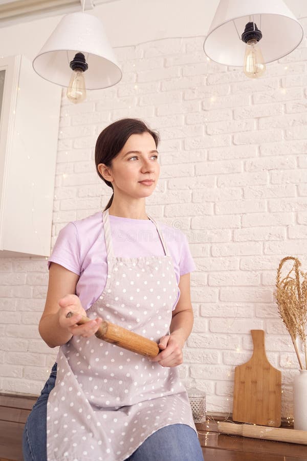 Woman in Polka Dot Apron Holding Rolling Pin in Modern Kitchen with White Brick Stock Image ...