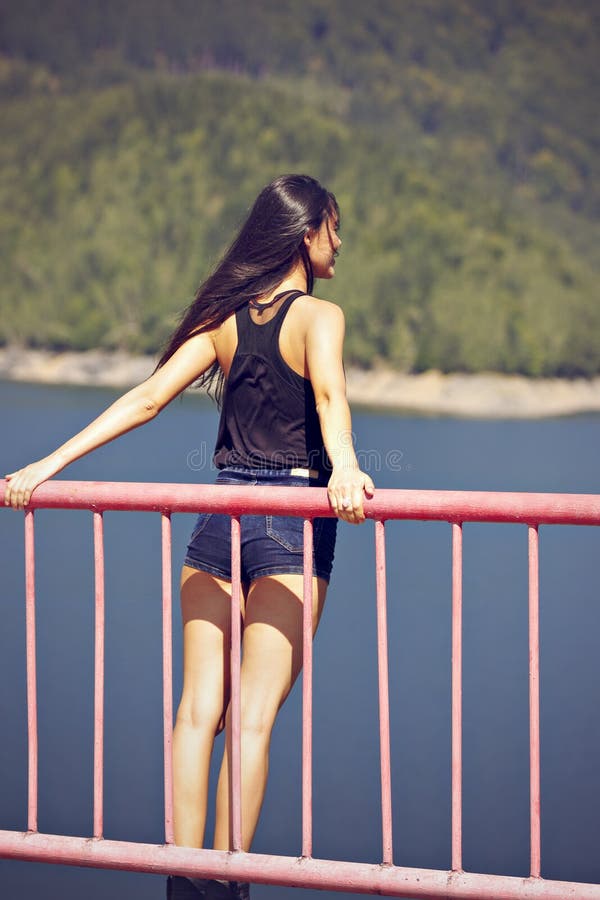 Woman posing on a bridge stock image. Image of standing - 59074399