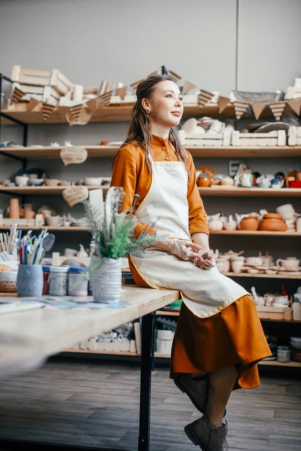 Woman Potter with Clay Sitting on Table in the Workshop Stock Image ...