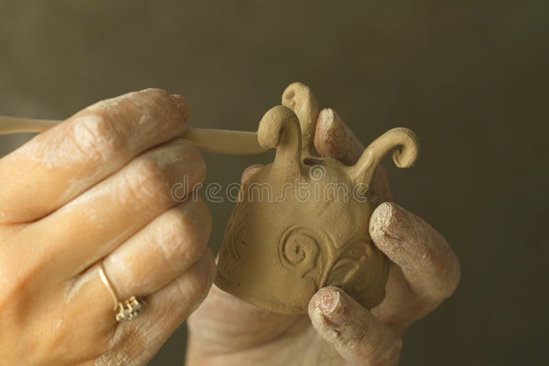 A Woman Potter Decorates a Clay Product with Patterns Using a Tool ...