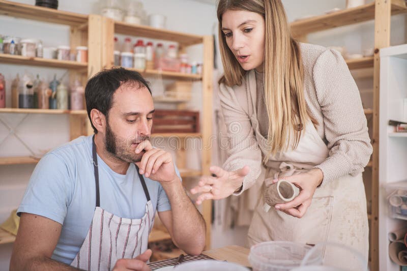 Woman Potter Helping Her Student in the Pottery Workshop. Stock Photo ...
