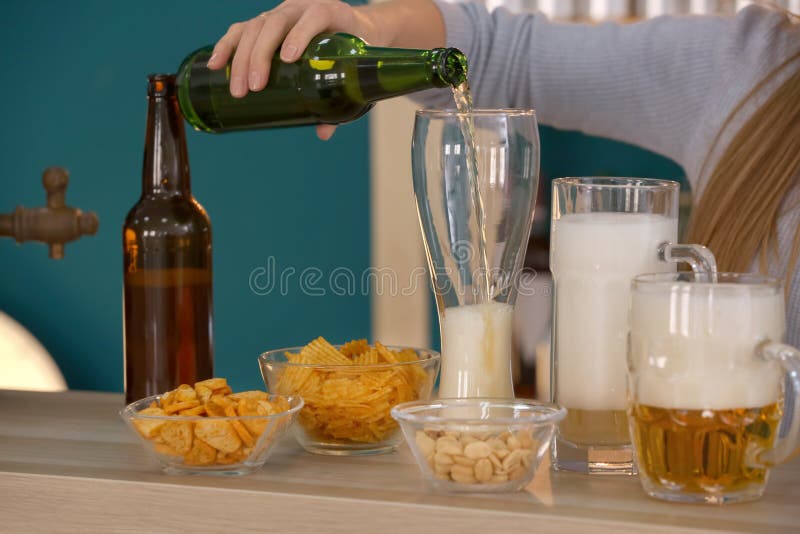 Woman Pouring Beer into Glass on Table in Bar Stock Photo - Image of ...