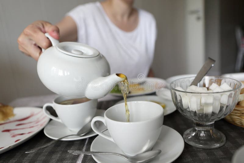 Woman pouring tea stock image. Image of activity, food - 74342409