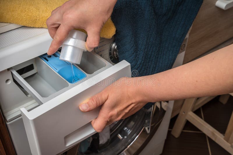 Woman Pouring Washing Powder into the Washing Machine Stock Photo ...