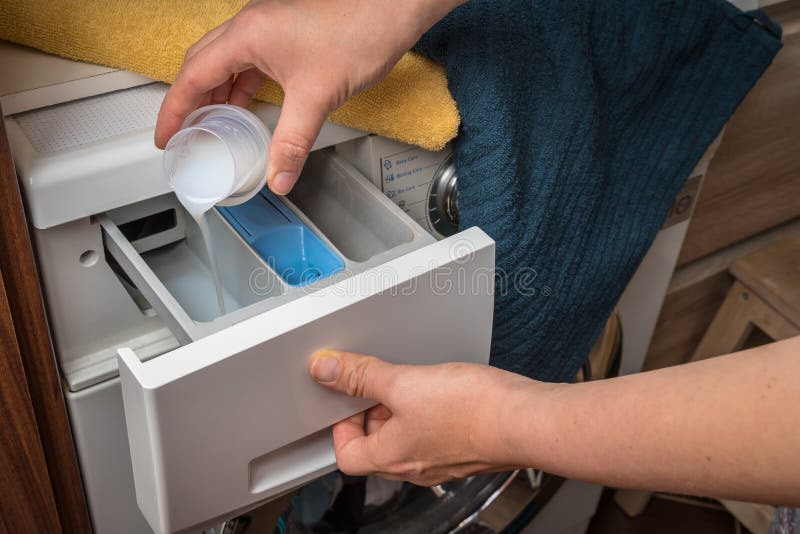 Woman Pouring Washing Powder into the Washing Machine Stock Photo ...
